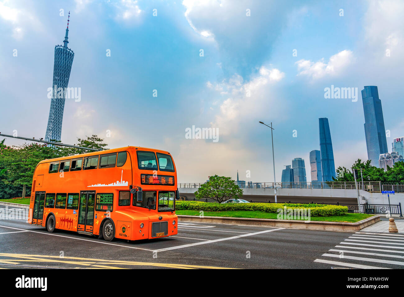 GUANGZHOU, CHINA - OCTOBER 21: Downtown city street with a tour bus ...