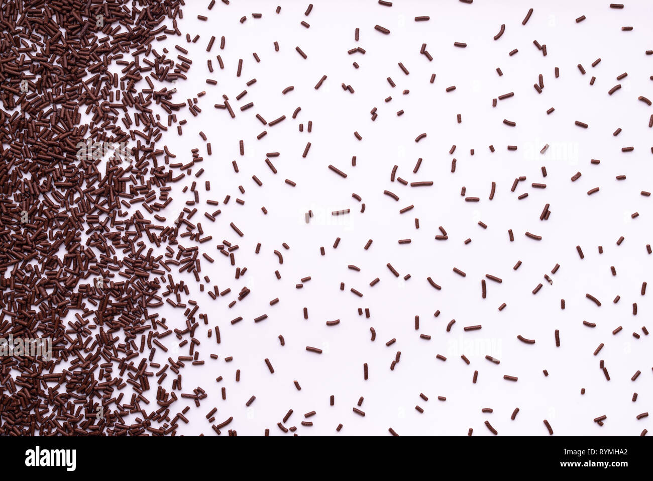 chocolate sprinkle dots, decoration over white background, flat lay ...