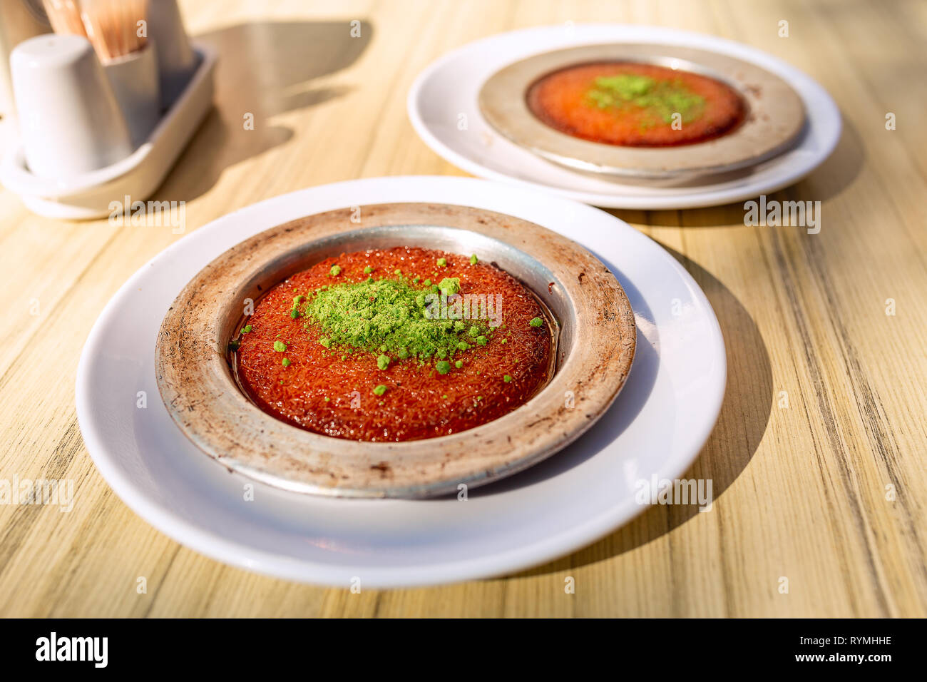 Turkish dessert kunefe, kunafa, kadayif with pistachio powder and ...