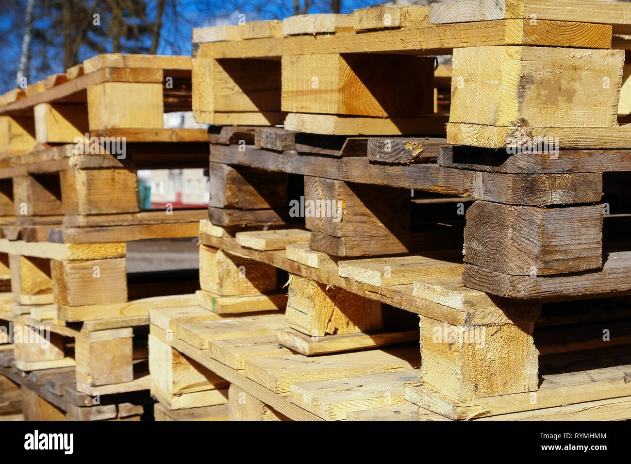 Wooden pallets piled on the street near the warehouse Stock Photo - Alamy