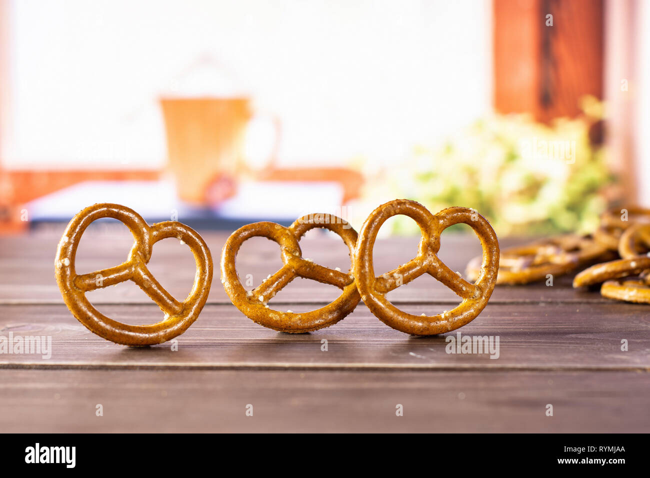 Group of three whole mini salted pretzels with books near the window ...