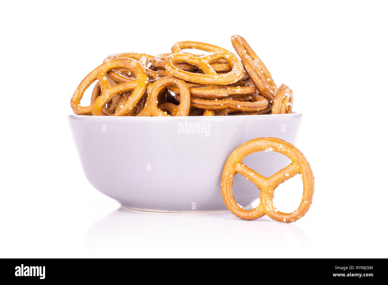 Lot of whole mini salted pretzels in a grey ceramic bowl isolated on ...