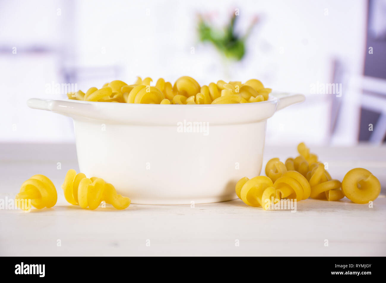 Lot of whole raw pasta funghetto variety in a ceramic stewpan with ...