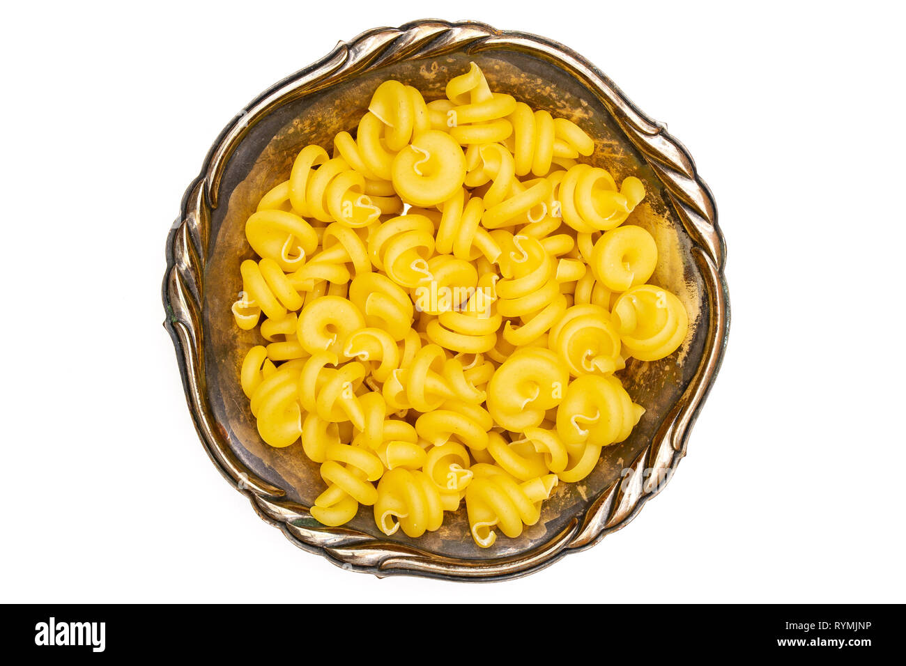 Lot of whole raw pasta funghetto variety in old iron bowl flatlay ...