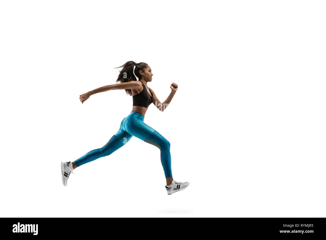 Young african woman running isolated on white studio background. One ...