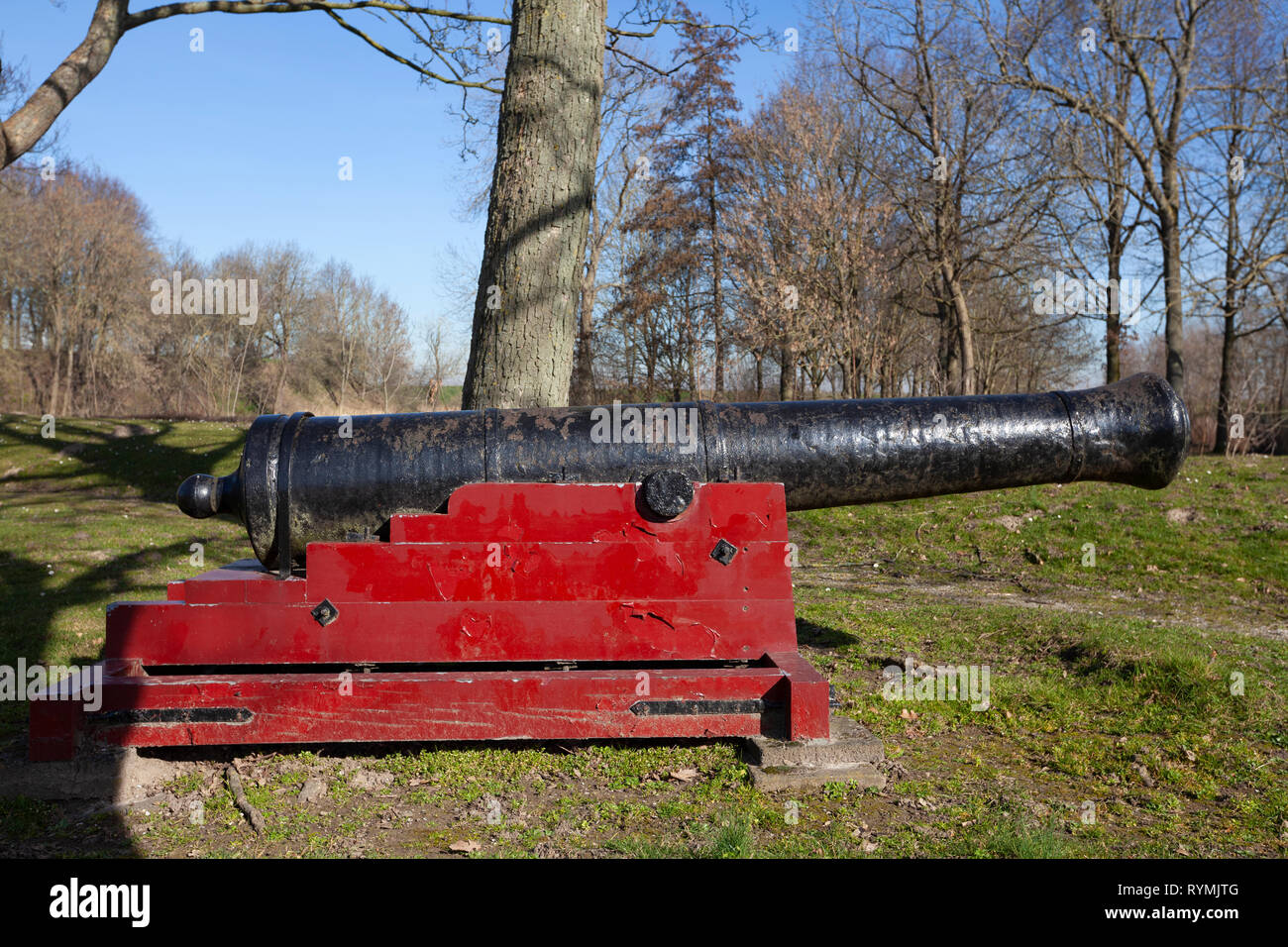 the old ship cannon with wooden carriage and black metal barrel in ...