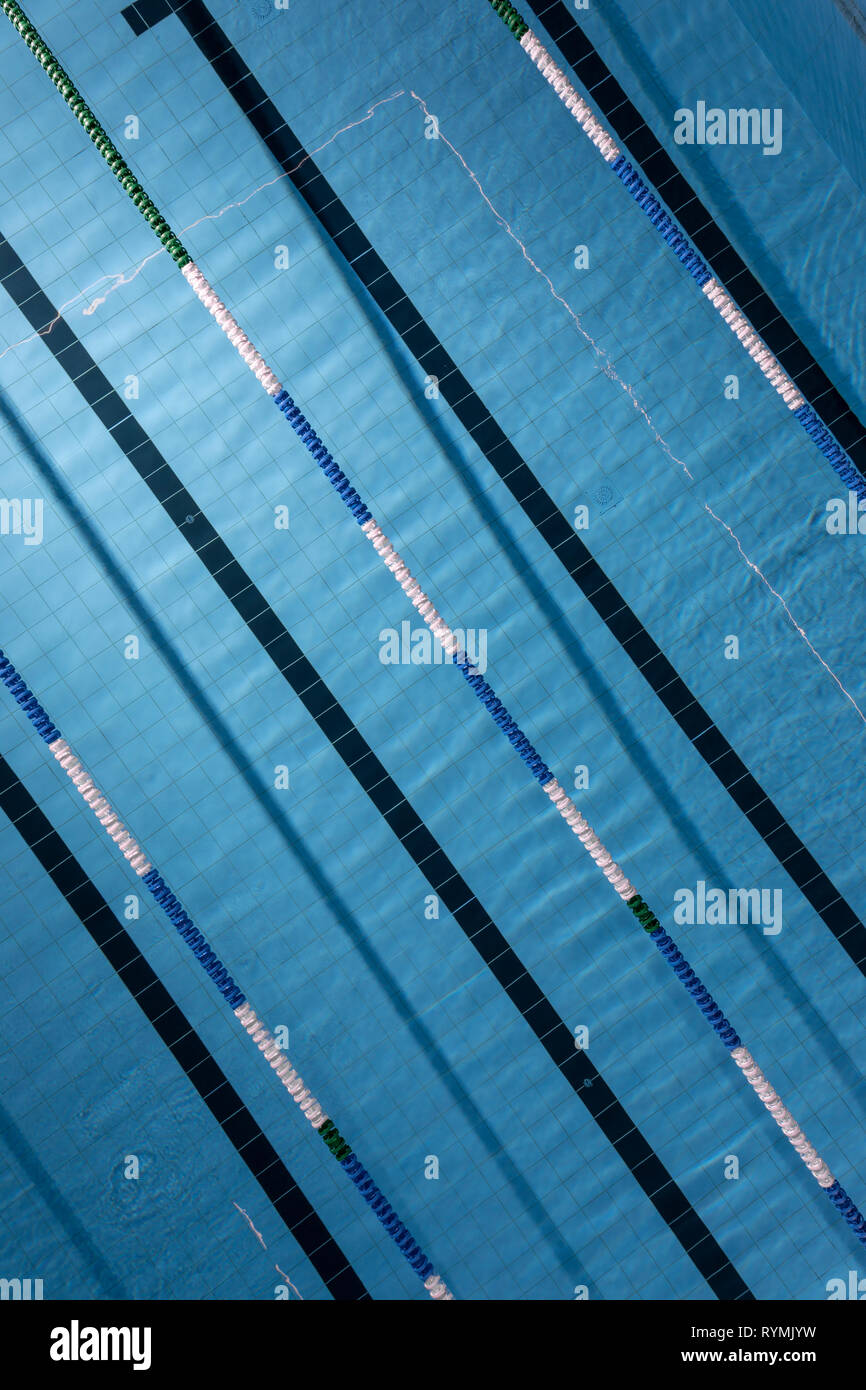 Water ripples on blue tiled olympic swimming pool background. View from ...