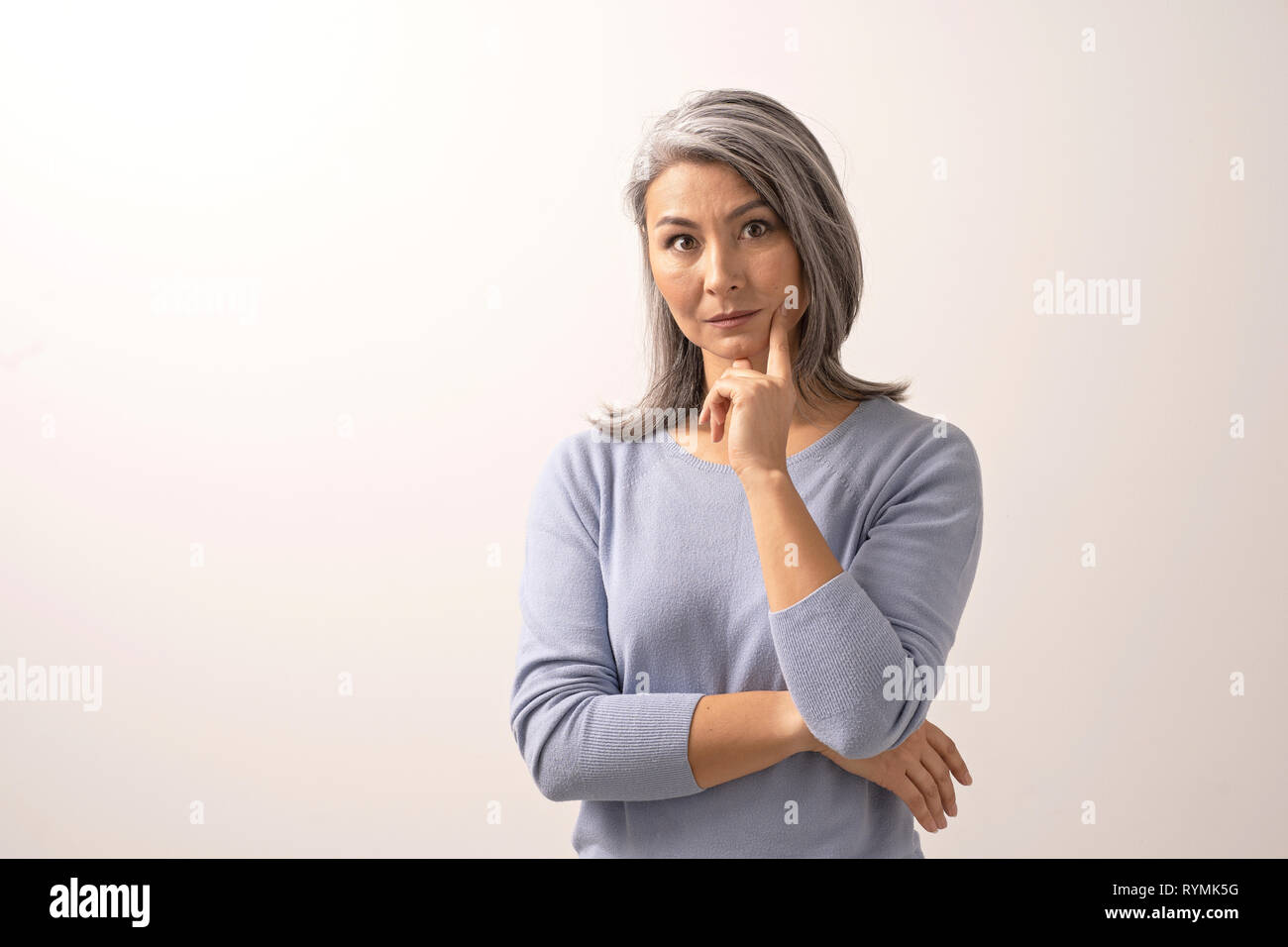 Asian woman smiling and pointing her finger to her cheek Stock Photo ...