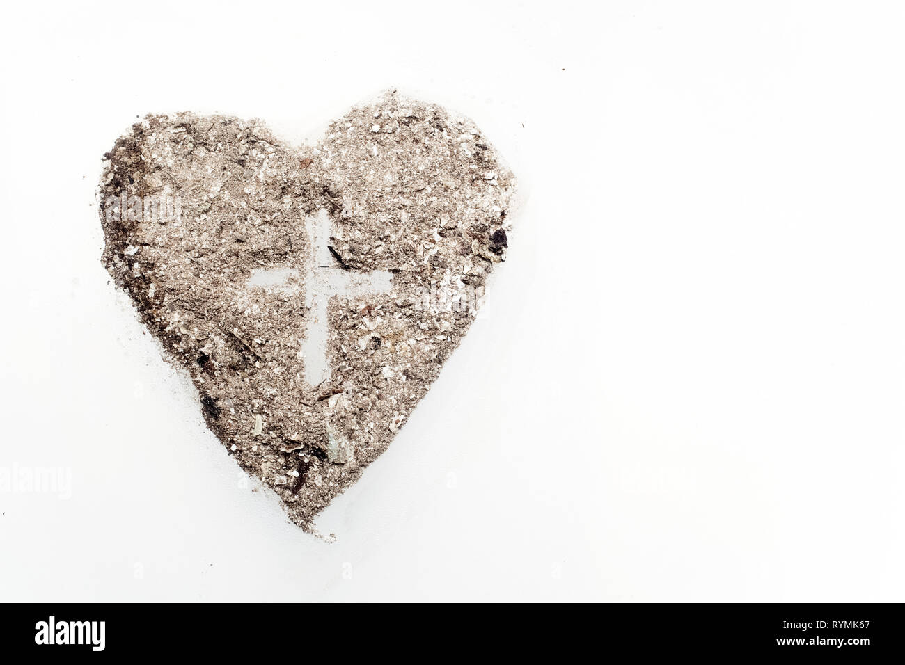 Cross or crucifix in heart symbol made of ash, lent and Ash Wednesday ...