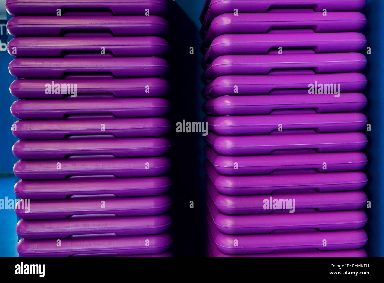Empty purple step platforms tacked in modern gym Stock Photo - Alamy