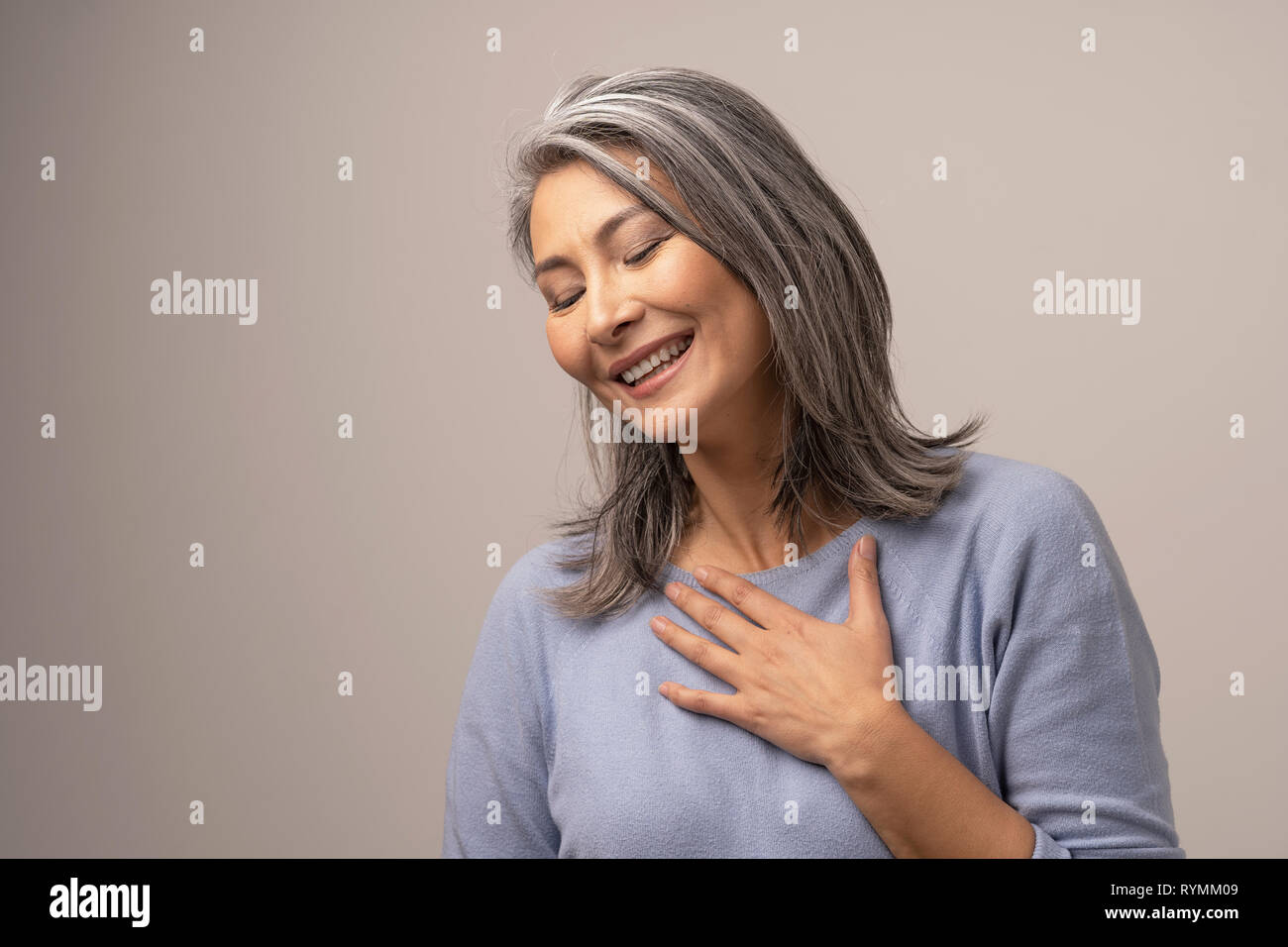 A Contented Adult Mongolian Woman with a Pleasant Smile Stock Photo - Alamy