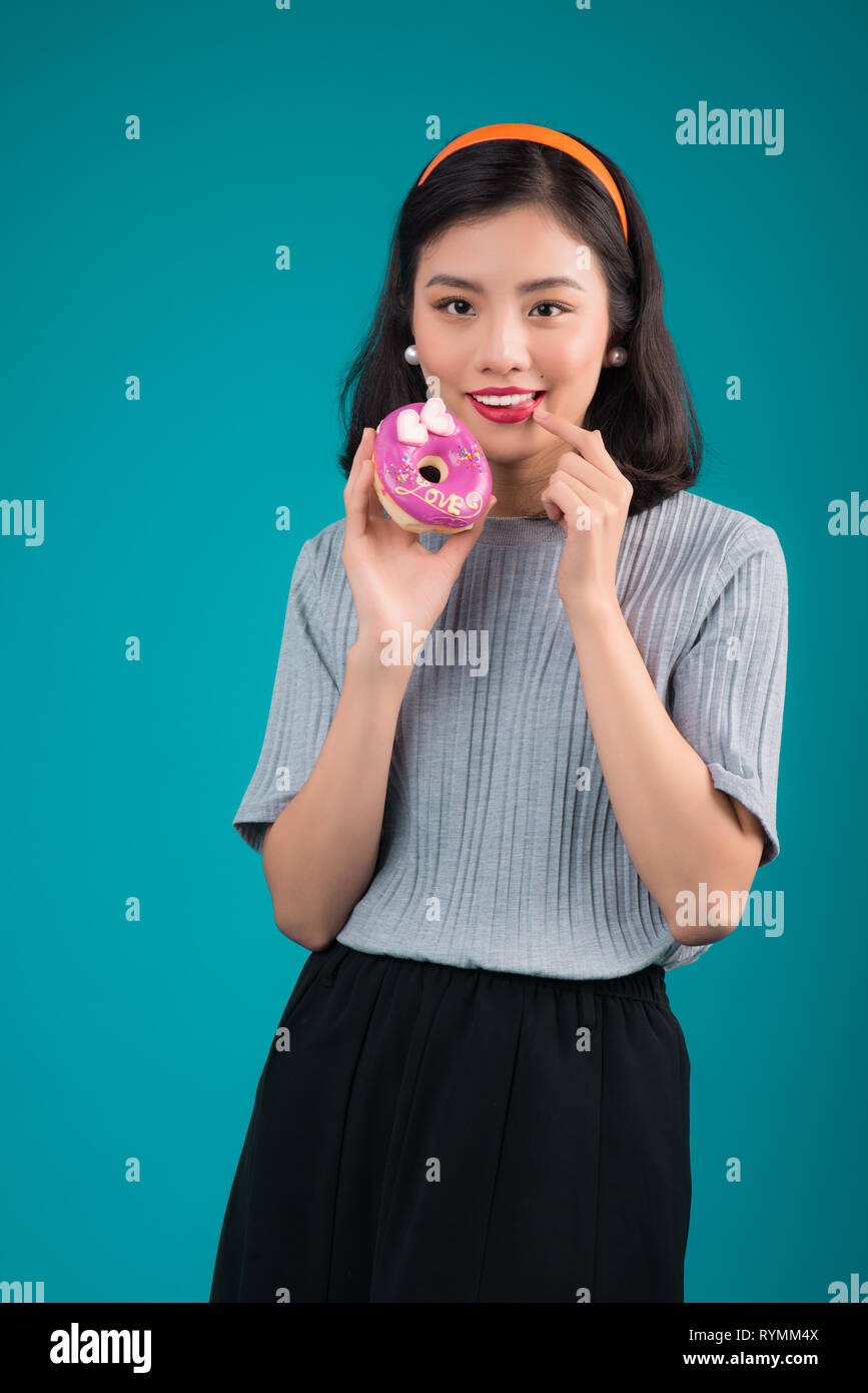 Asian beauty girl holding pink donut. Retro joyful woman with sweets ...