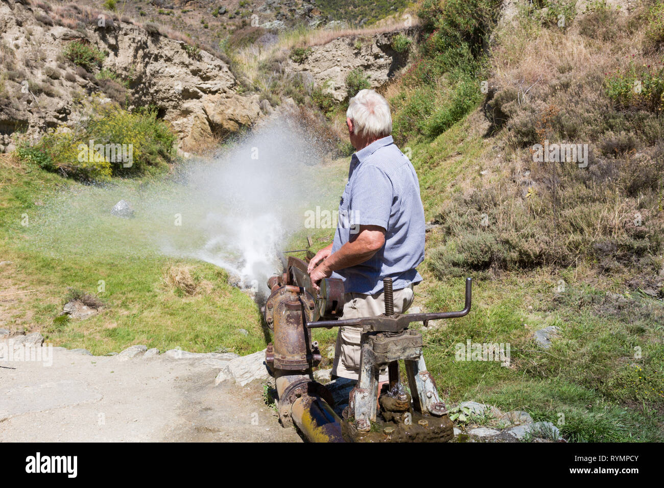 Man demonstrating a sluice, Goldfields Mining Centre, New Zealand Stock ...