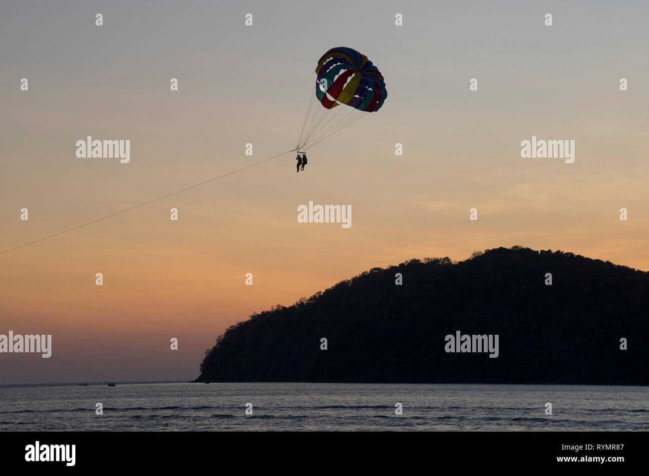 Western tourists sky gliding on a beach in the island of Langkawi ...