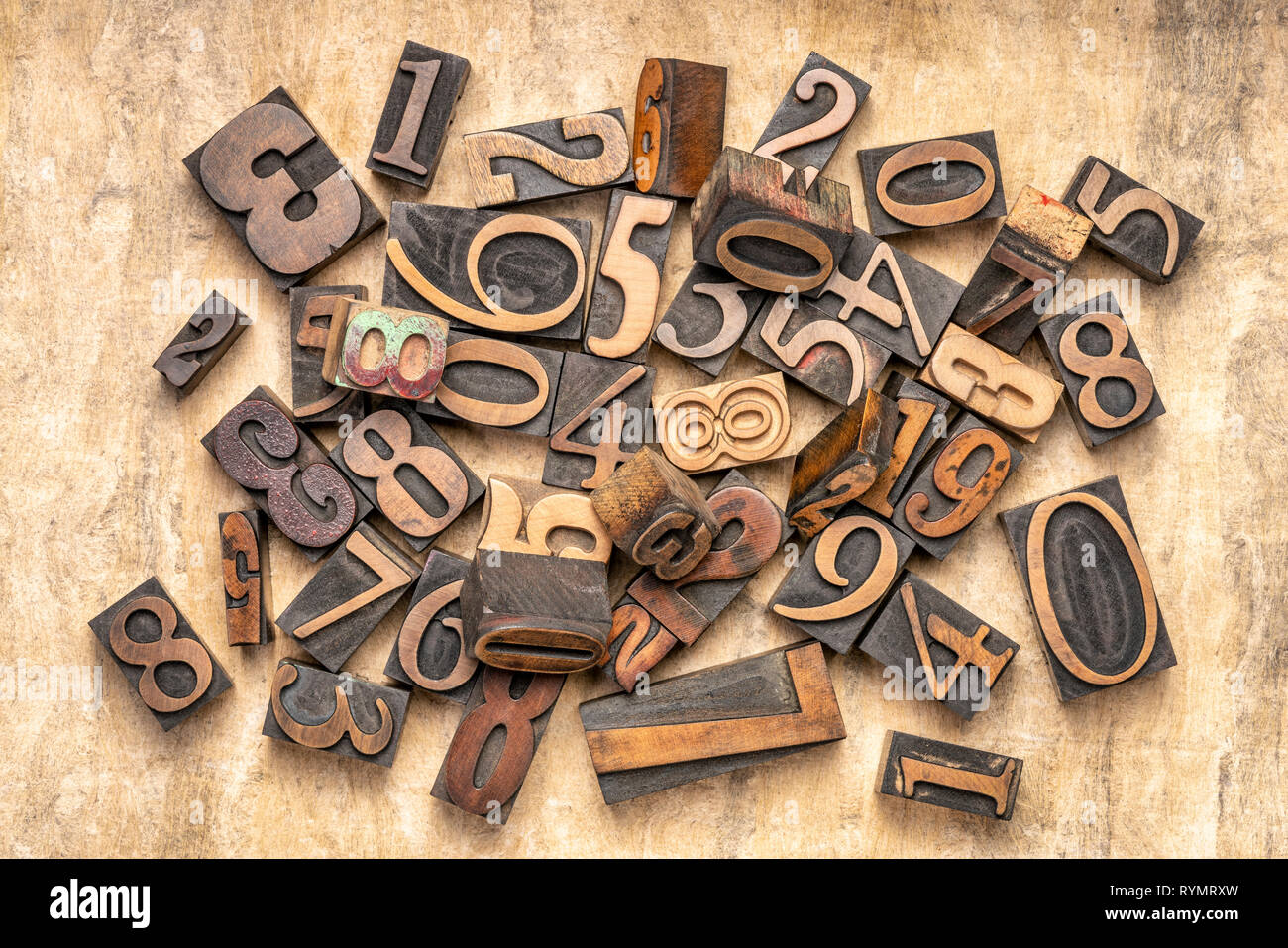 pile of random numbers in letterpress wood type against textured bark ...