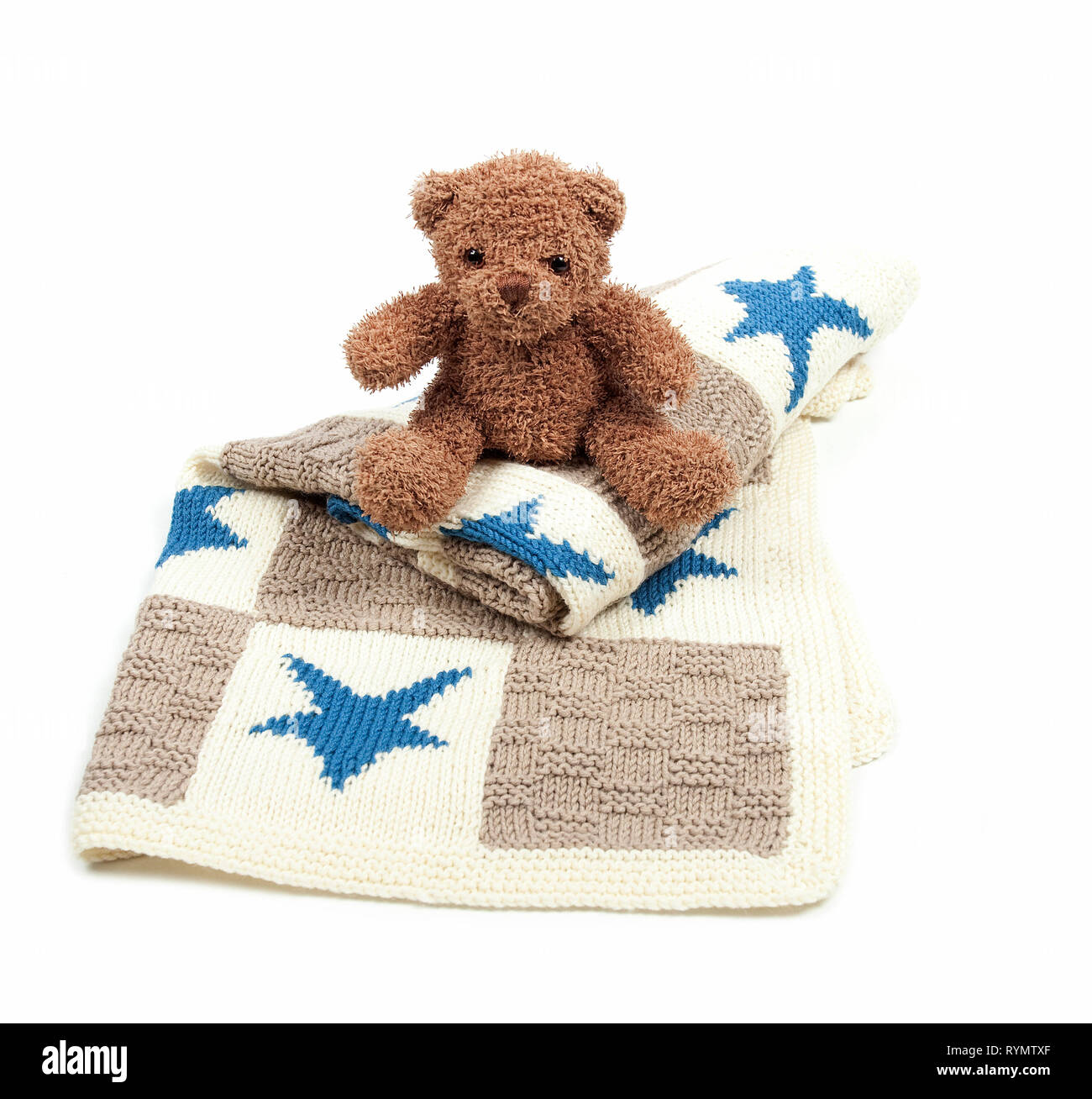 Teddybear sat on knitted blanket on isolated white background Stock ...