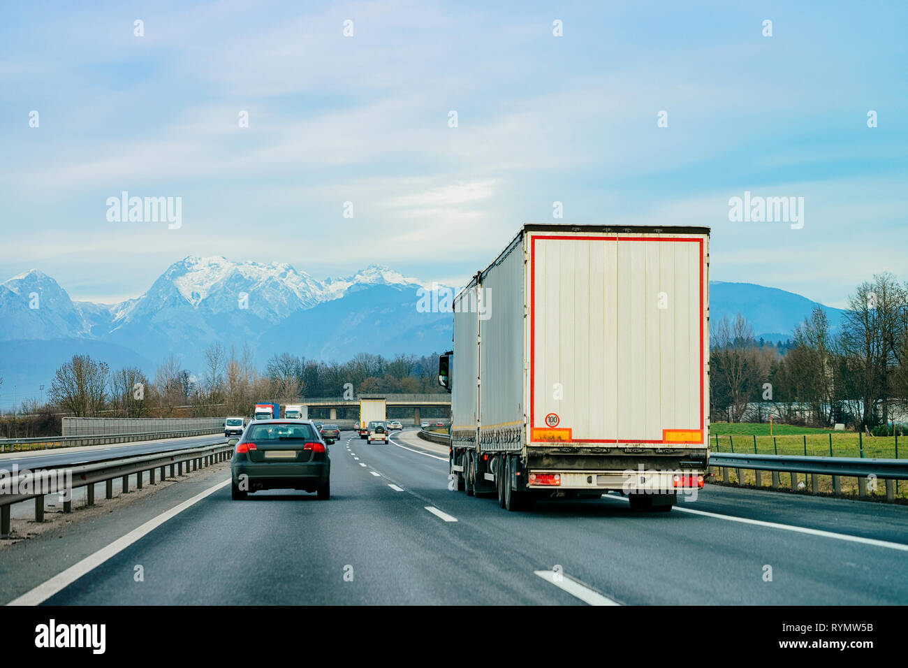Truck on road. Trucker on highway. Lorry doing logistics work. Semi ...