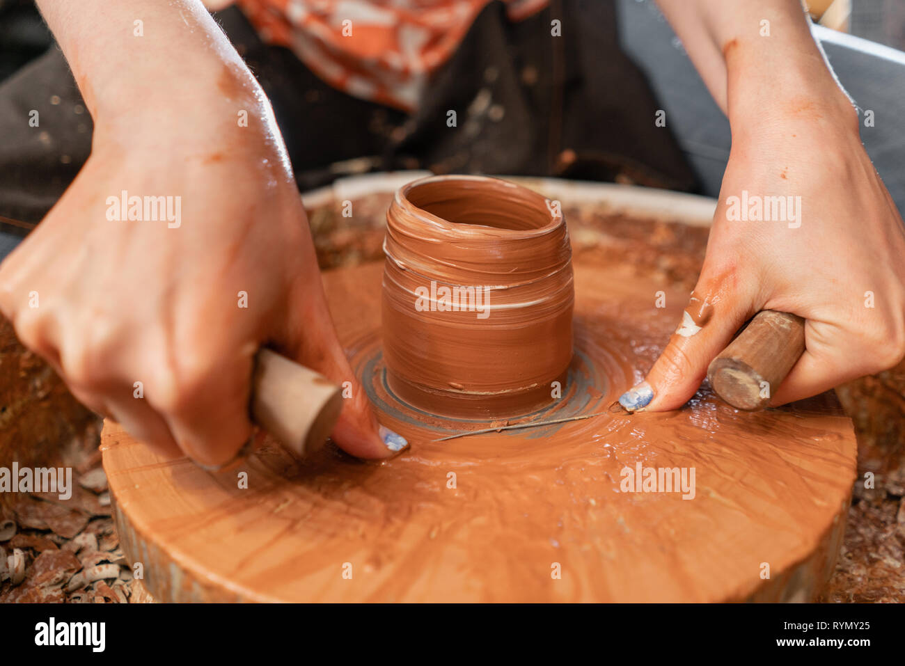 Craftsman hands making pottery bowl. Woman working on potter wheel ...