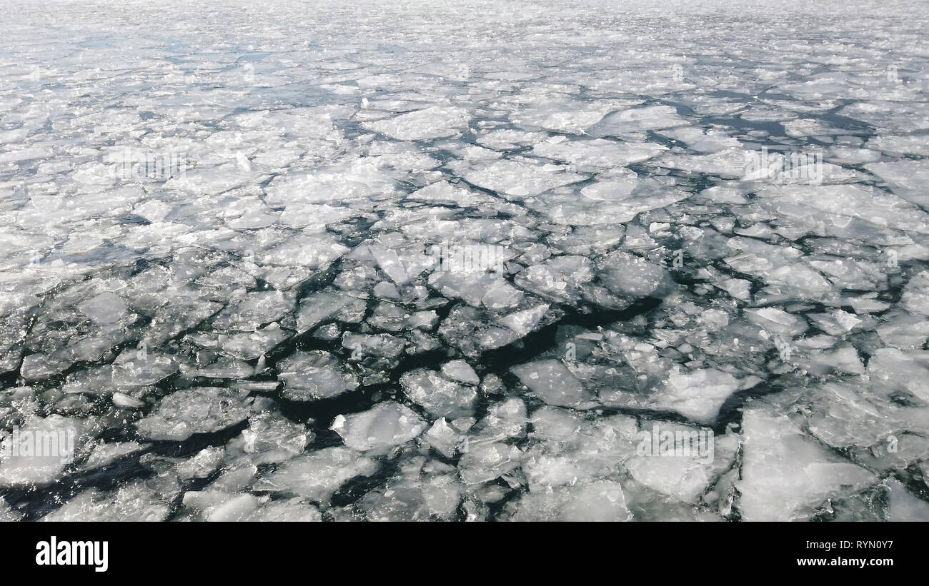 surface of the ocean covered in cracked and melting ice Stock Photo - Alamy