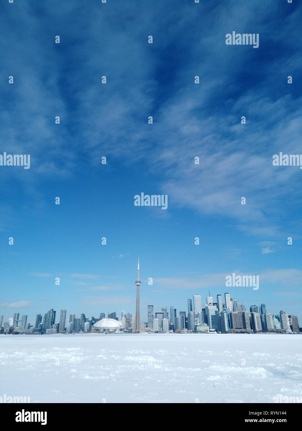 Toronto city skyline seen from toronto Islands over frozen lake Ontario ...