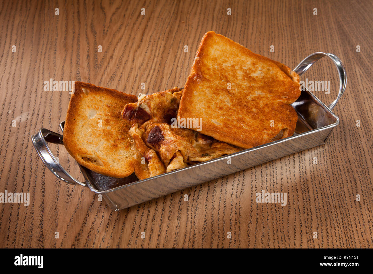 Slices of toasted bread with trimmed cheese and scrambled eggs served ...