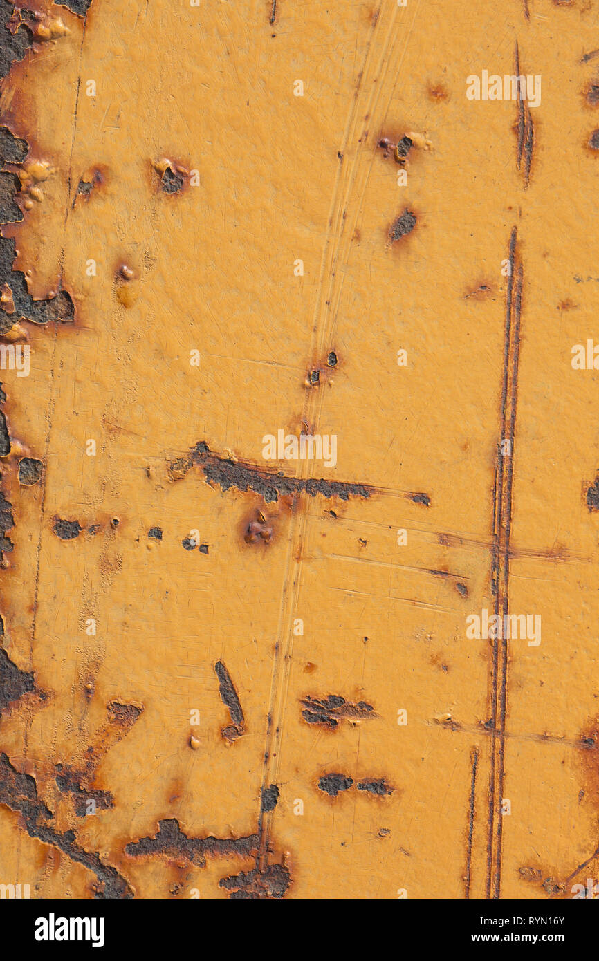 Yellow painted metal surface with rust and scratches as texture or ...