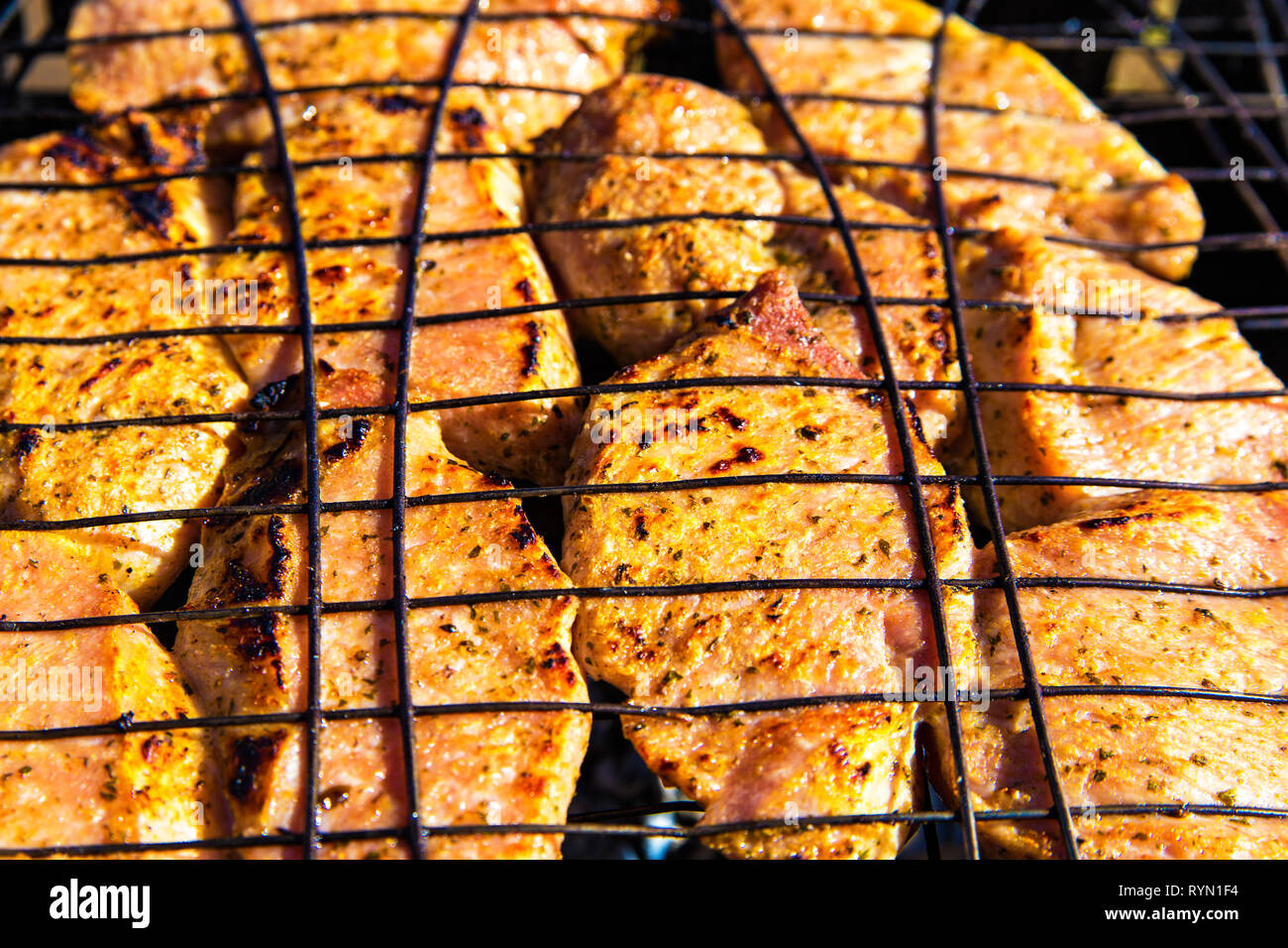 Pork spicy steak in marinade roasted on braai. Barbecue with delicious ...