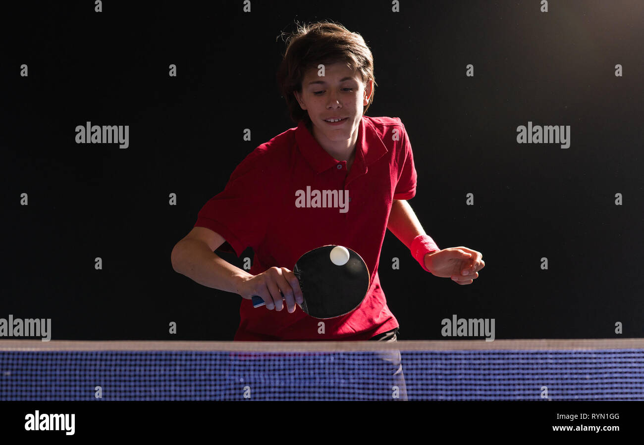 Young boy playing ping pong table tennis indoor Stock Photo - Alamy