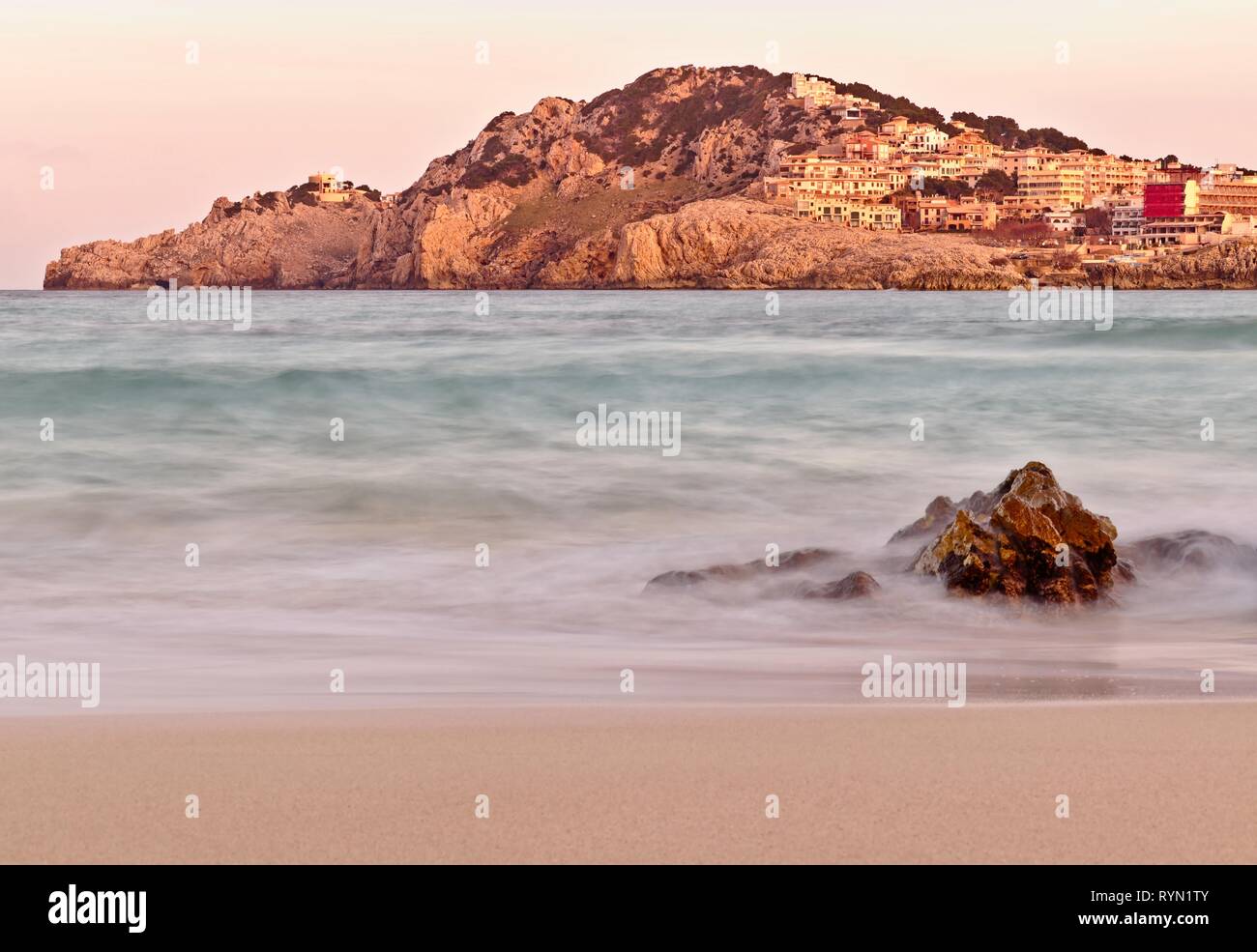 Cala agulla (crocodile) at sunset, with empty beach and rocks in ...