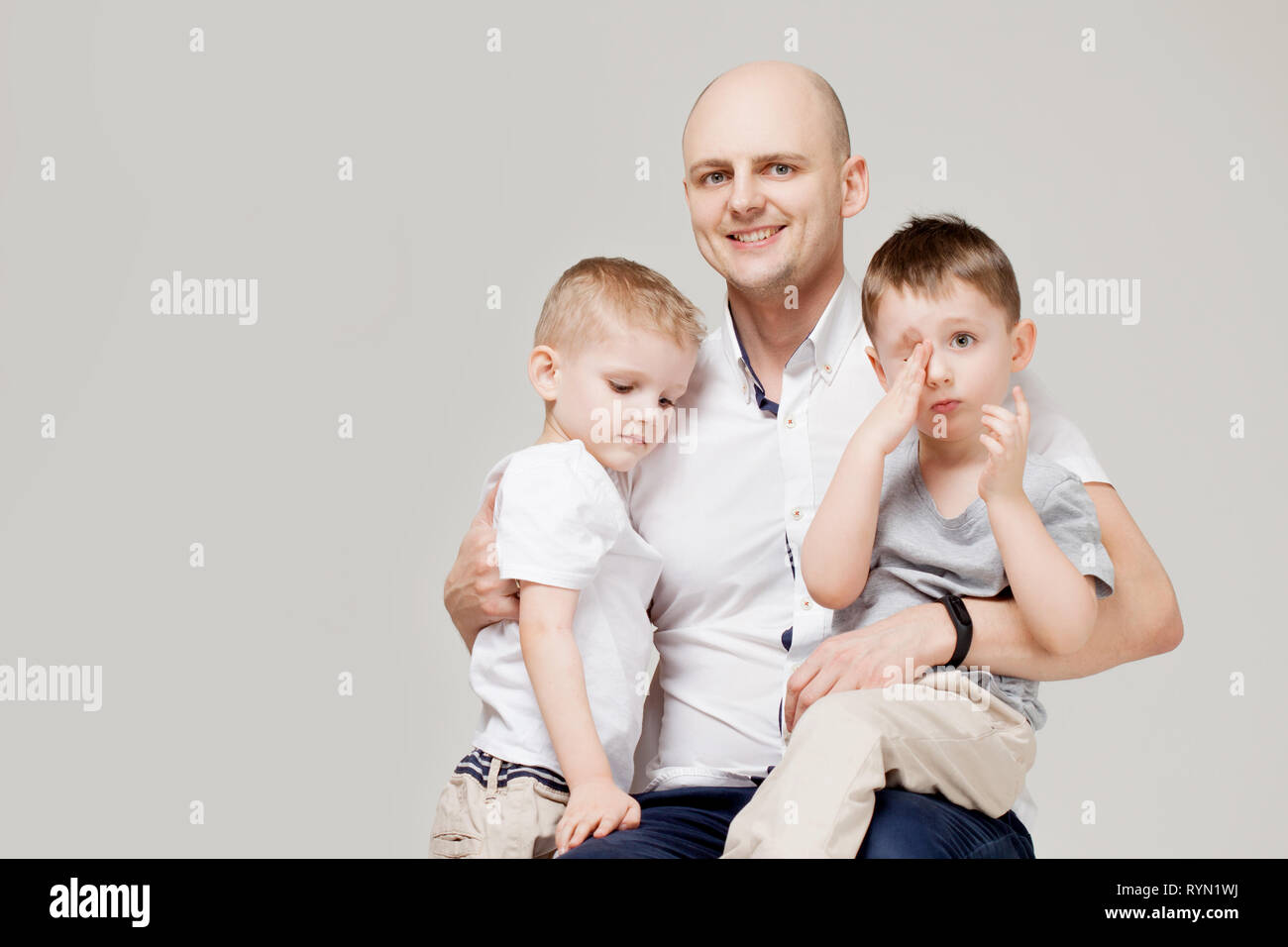 father and his two sons, the young man raising children, the concept ...