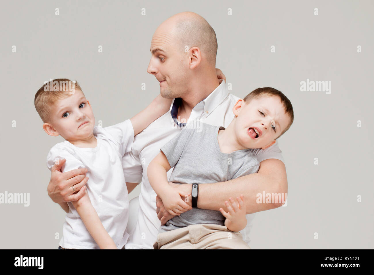 father and his two sons, the young man raising children, the concept ...