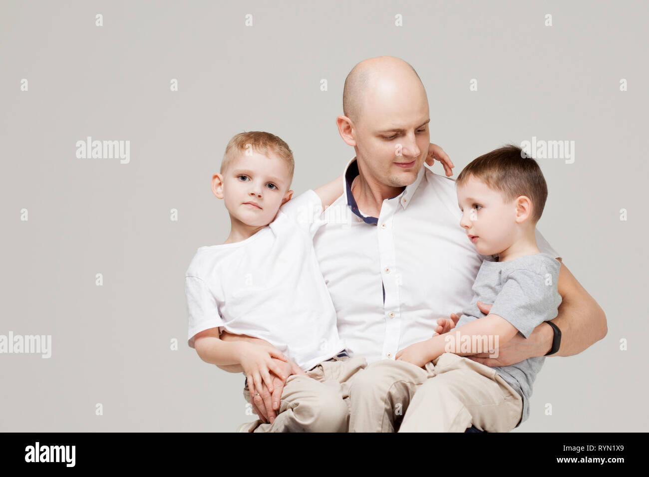 father and his two sons, the young man raising children, the concept ...