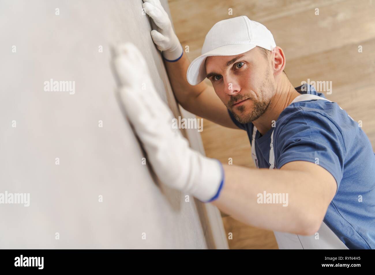 Professional Tile Installer and Quality Check on Ceramic Tiles Wall ...