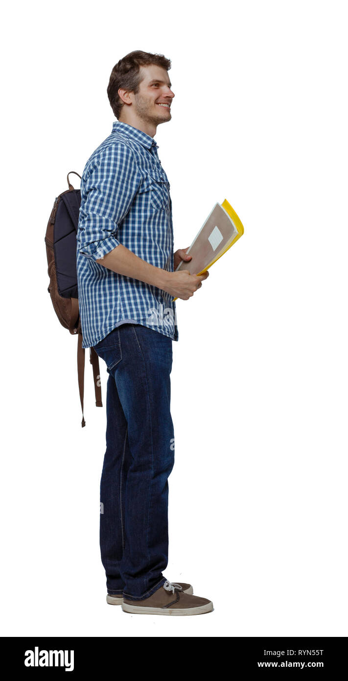Side view of a student. guy with the backpack and textbooks. Rear view ...