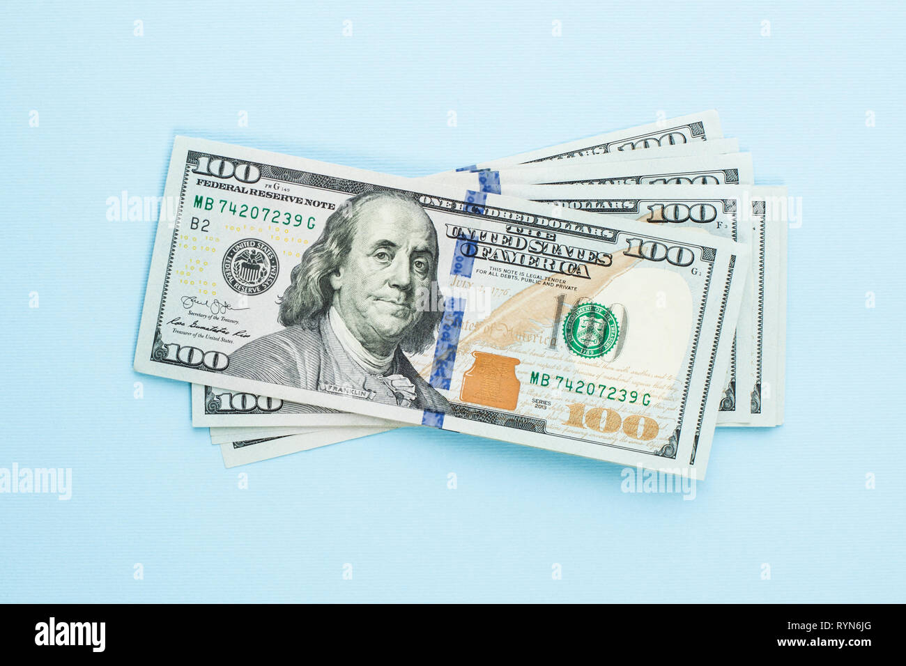 Heap of hundred dollars. Modern 100 us dollar bills on blue background ...