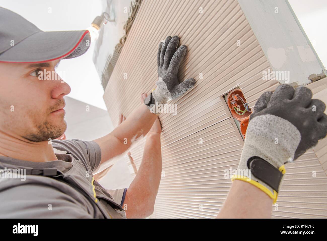 Two Caucasian Workers Installing Large Modern Ceramic Tile Inside ...