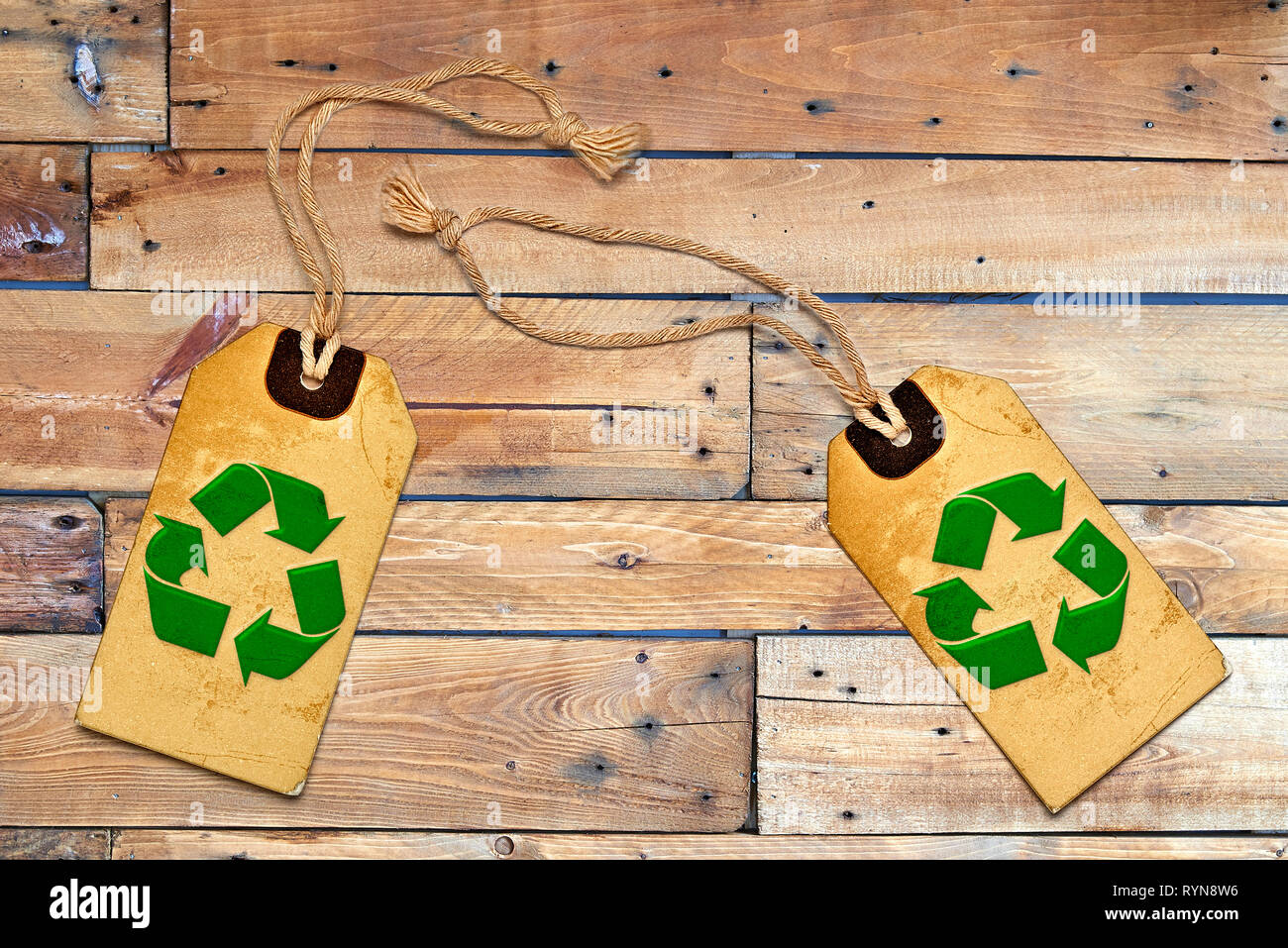 Two natural label tags and recycling symbol on wooden table view from ...