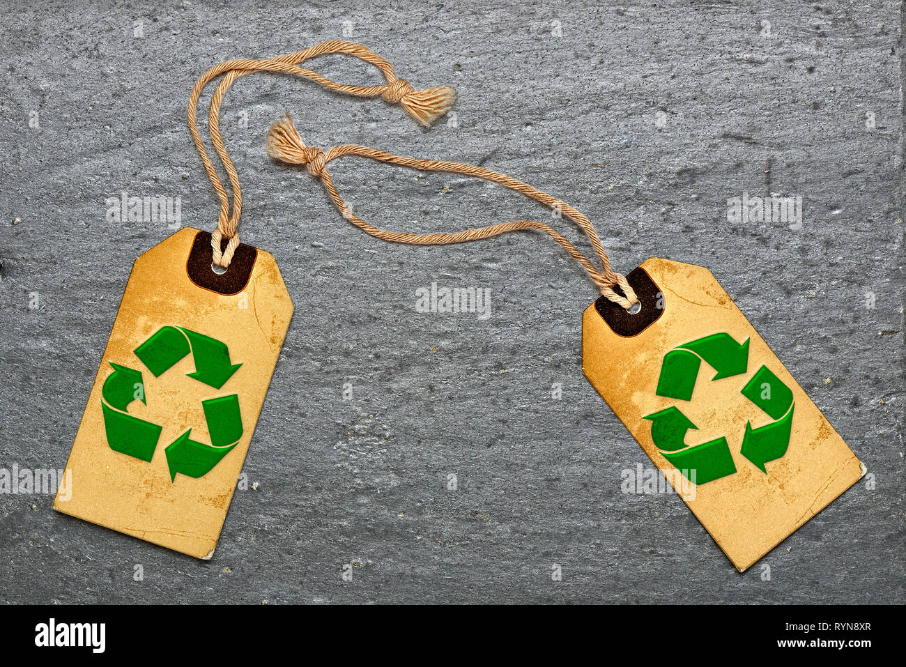 Two natural label tags and recycling symbol on Black textured granite ...