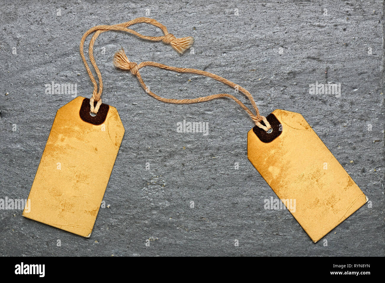 Two natural label tags on Black textured granite slate Stock Photo - Alamy