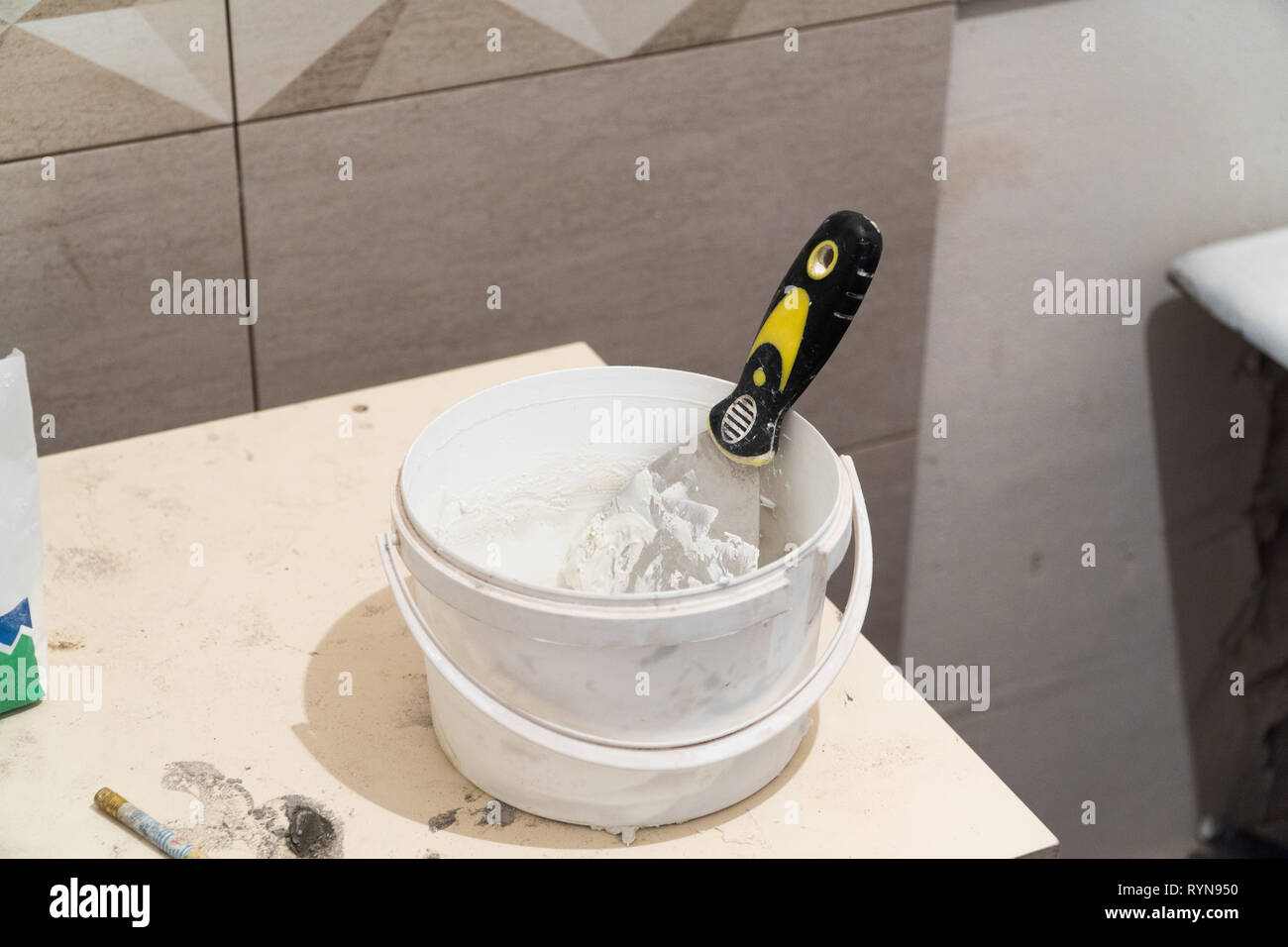 A bucket of putty for tile joints. Finishing works. The technology of ...