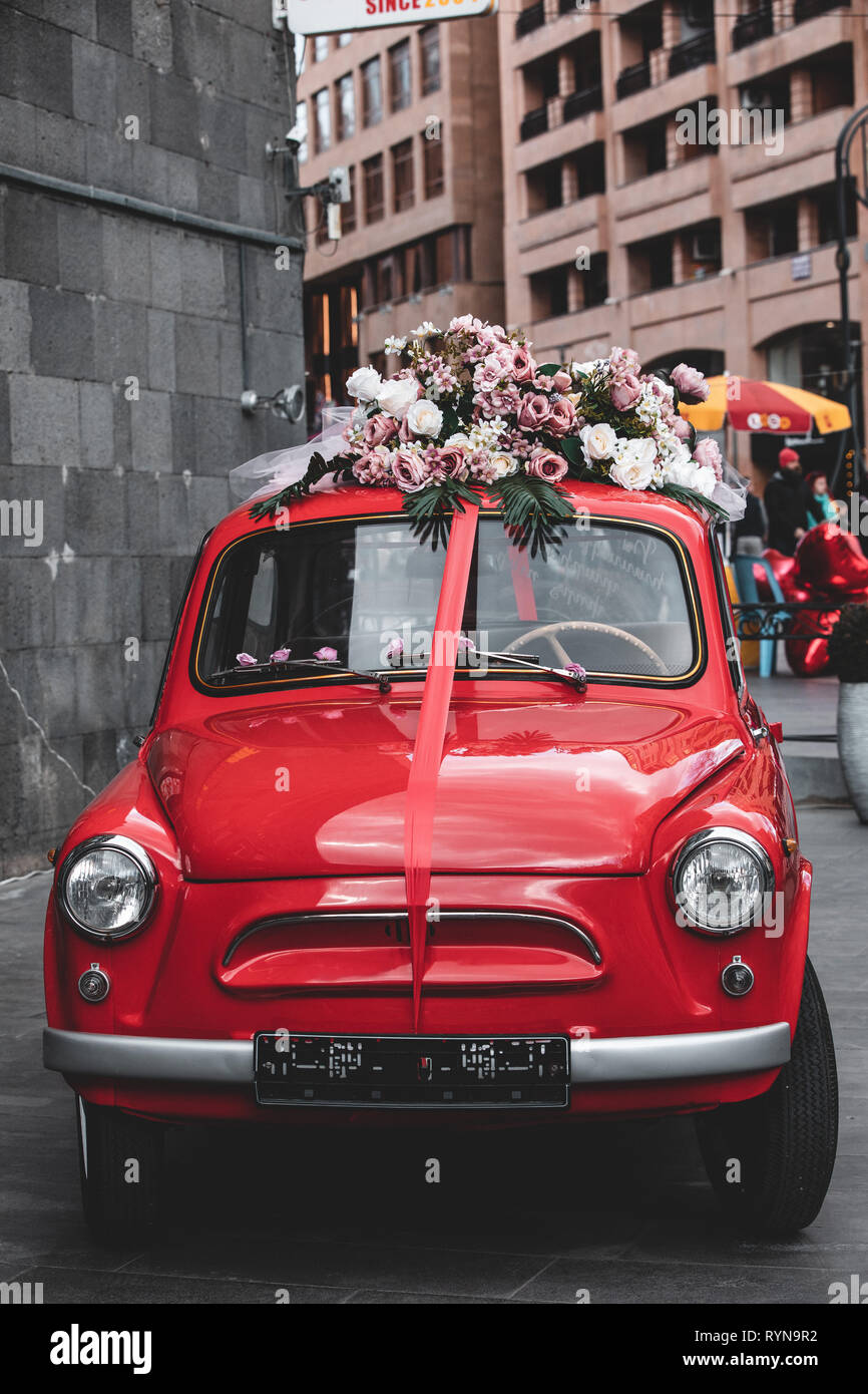 Old red car with a ribbon Stock Photo - Alamy