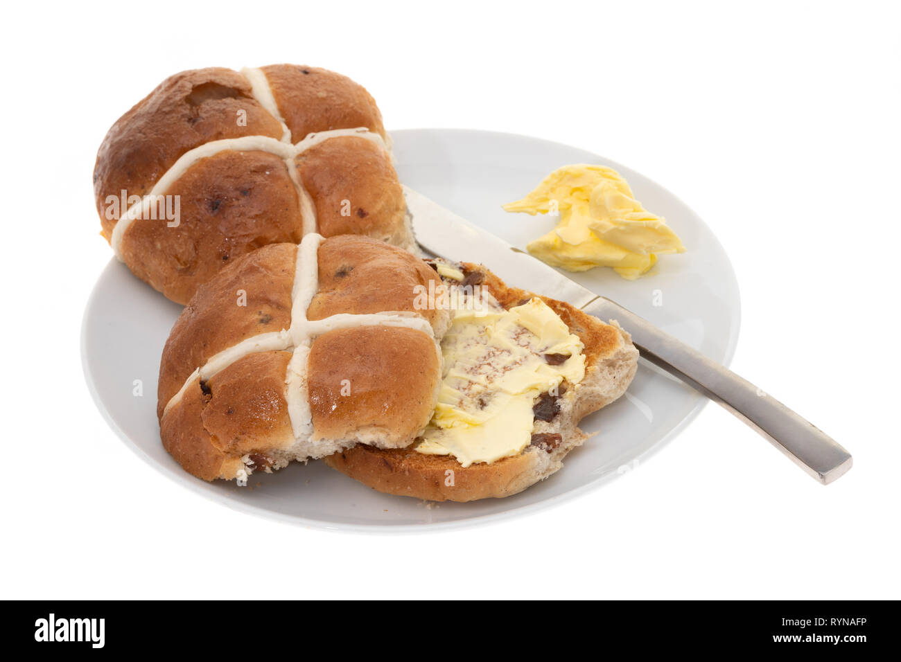 Hot cross buns with butter- white background Stock Photo - Alamy