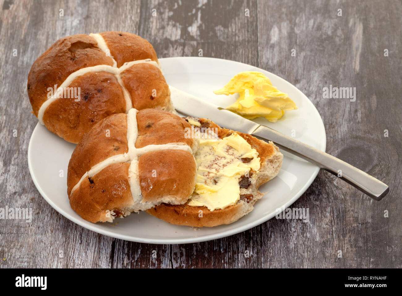 Hot cross buns with butter Stock Photo - Alamy