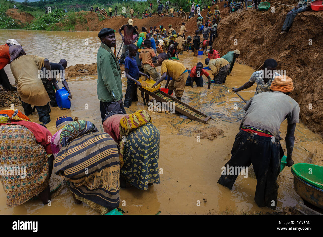 A security guard oversees artisanal miners at a gold mine near Iga ...