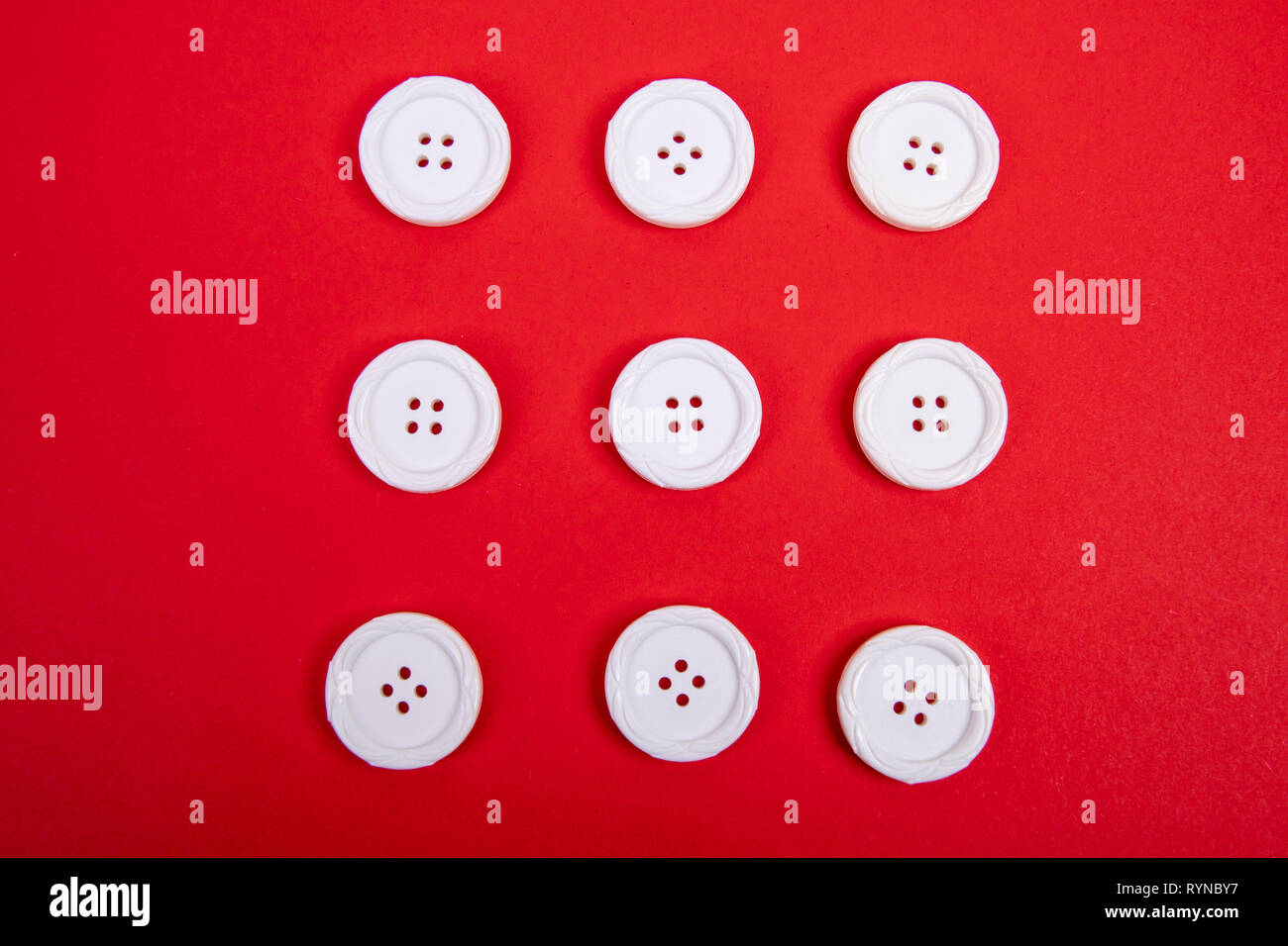 nine white buttons on a red background Stock Photo - Alamy