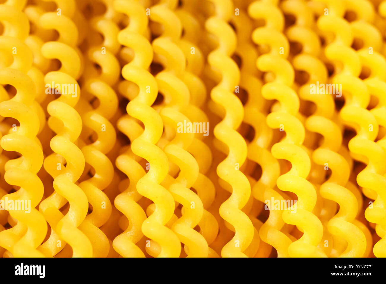 Raw Italian pasta called fusilli detail, long thin corkscrew shaped ...
