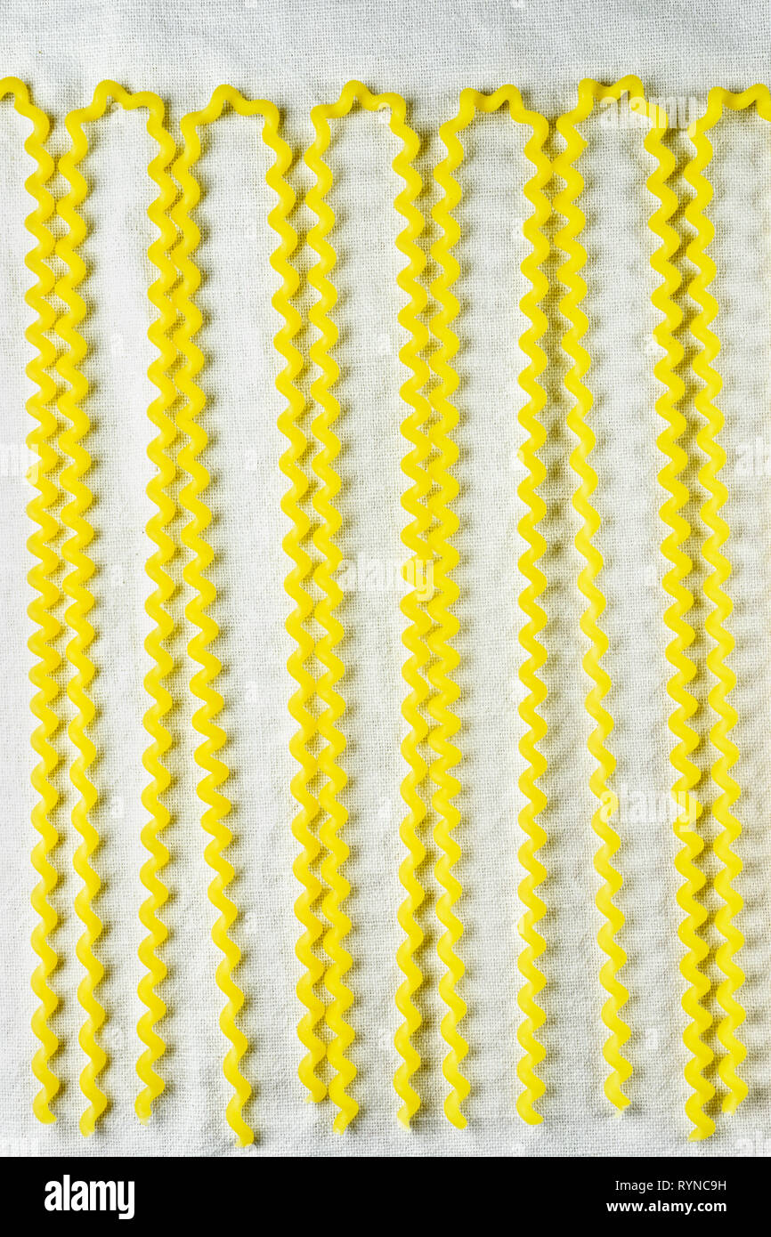 Raw Italian pasta called fusilli , long thin corkscrew shaped pasta on ...