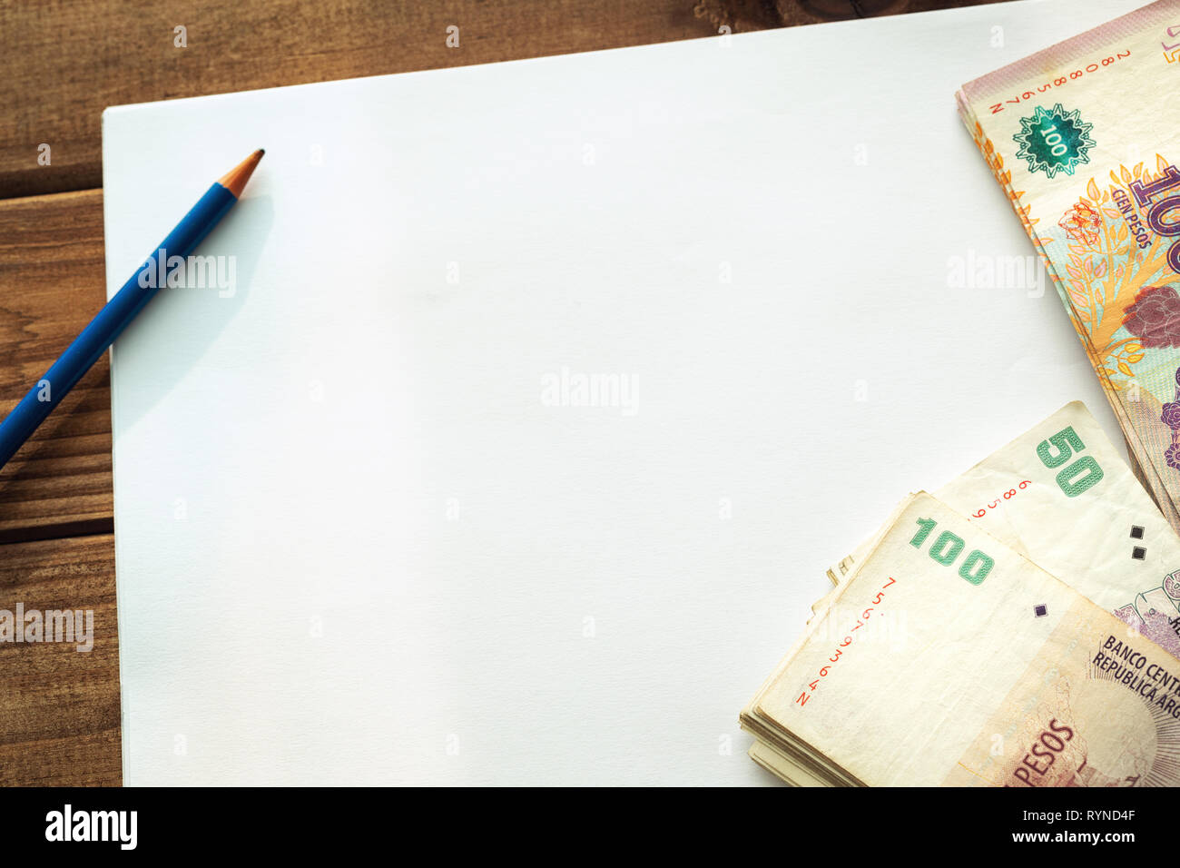 Argentine money, pesos on the table with a white, blank card and a ...