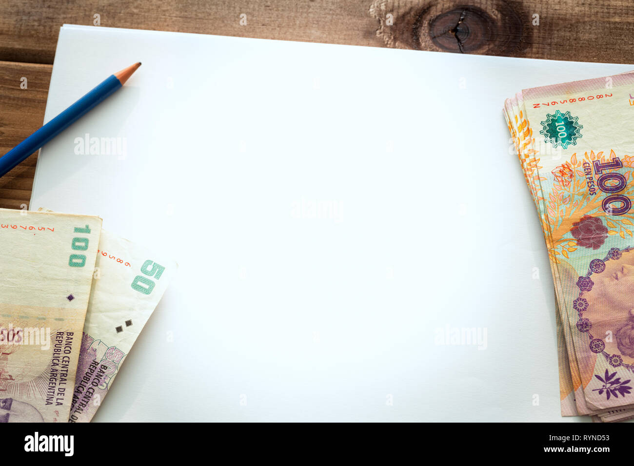 Argentine money, pesos on the table with a white, blank card and a ...