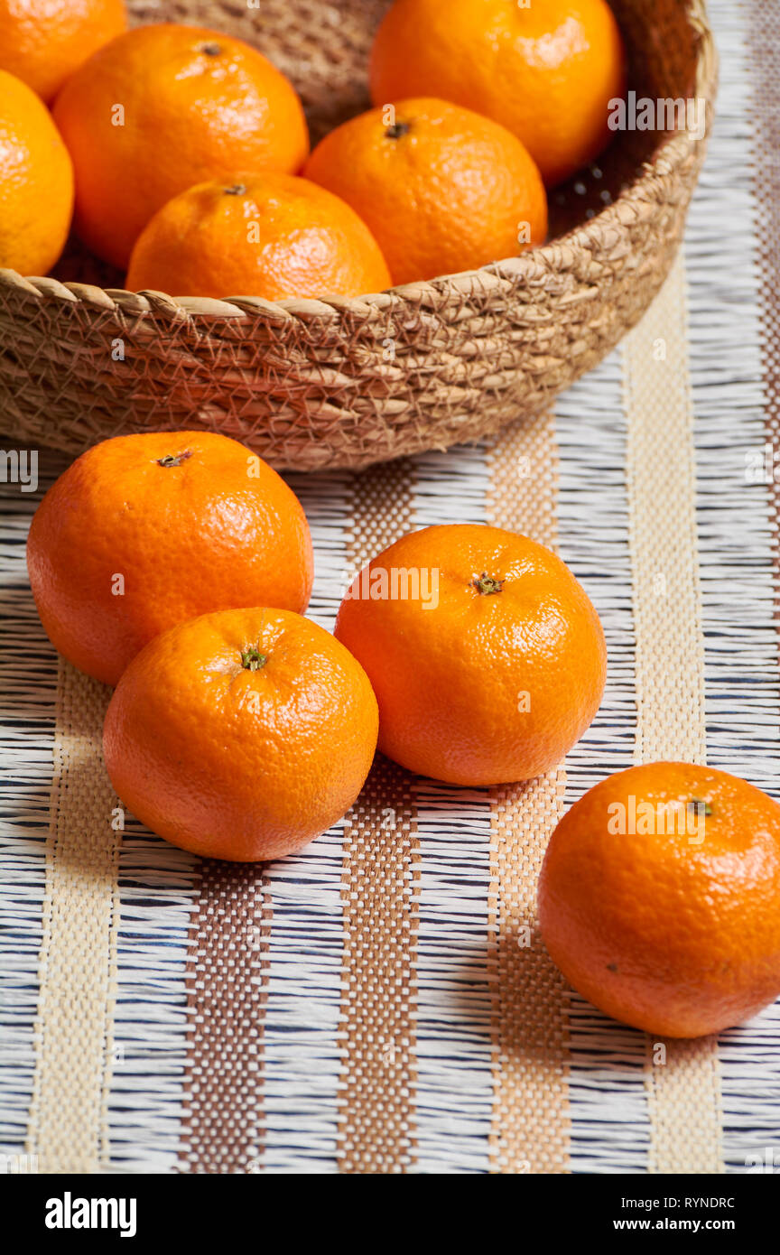 tangerine basket with artisan tablecloth background Stock Photo - Alamy